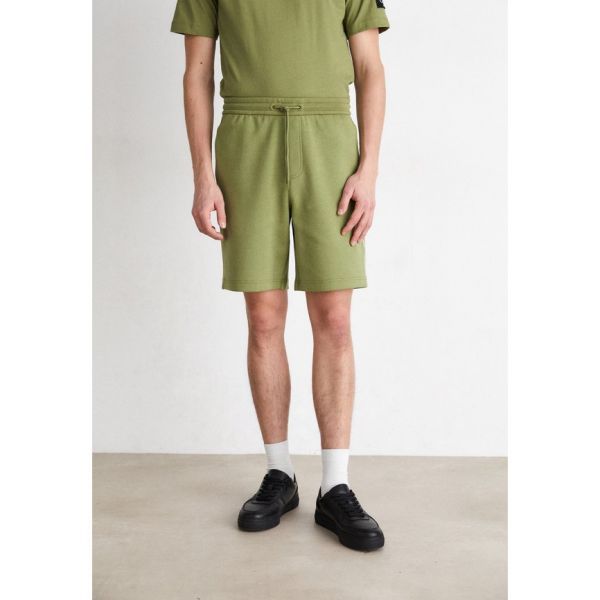 4343152 Calvin Klein LOGO REPEAT - Tracksuit bottoms dark juniper ...